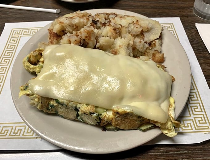 This isn't just an omelet – it's a cheese-draped miracle that makes you wonder why you ever bothered with those sad homemade versions.