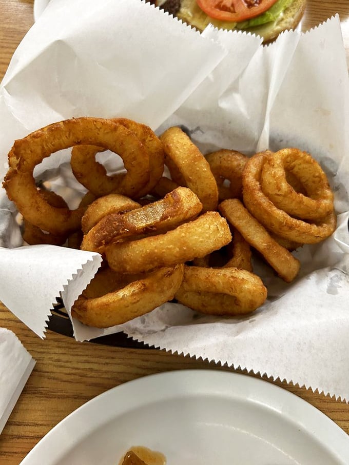 These onion rings aren't just fried – they're golden halos of happiness, crispy enough to make angels weep with joy.