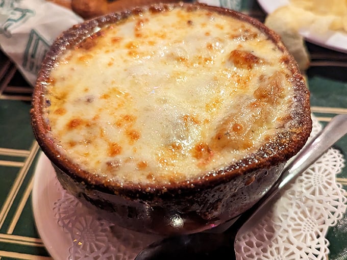 French onion soup bubbling under a blanket of melted cheese – winter comfort in a ceramic bowl.