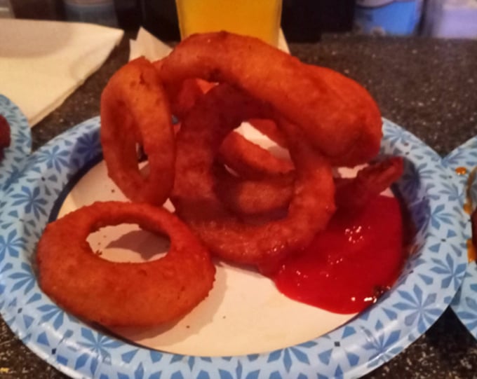 These onion rings aren't just fried – they're transformed into golden halos of crunch that make ketchup feel like it finally met its soulmate.