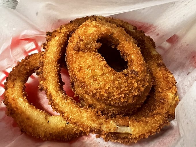 These onion rings aren't just side dishes—they're golden halos of happiness that crunch loud enough to drown out your diet's protests.