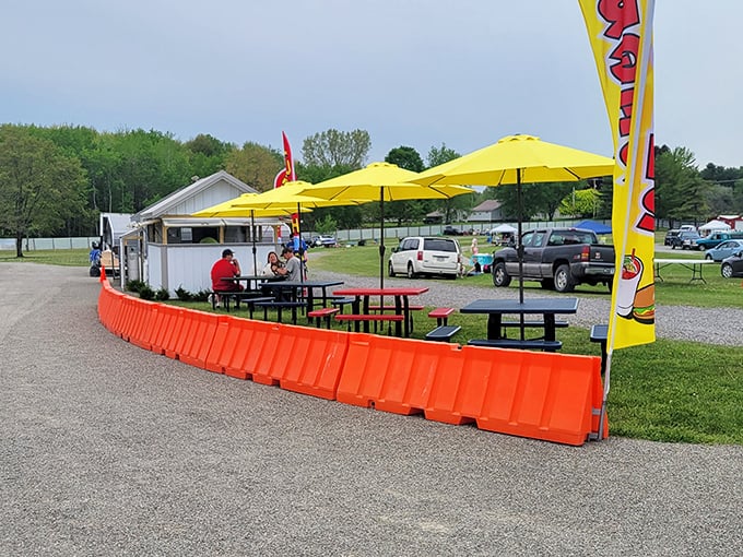 The flea market's dining area offers a moment of respite under cheerful yellow umbrellas—because treasure hunting requires proper fueling stations.