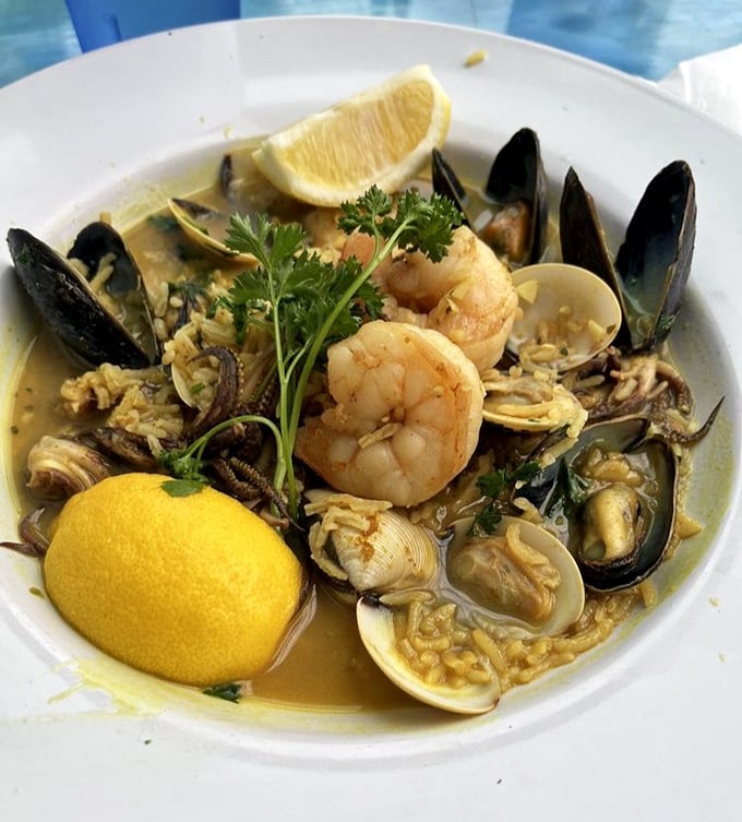 A seafood paella that plays like a symphony—mussels, clams, shrimp, and more, all coming together in golden rice. A squeeze of lemon conducts the final flourish.