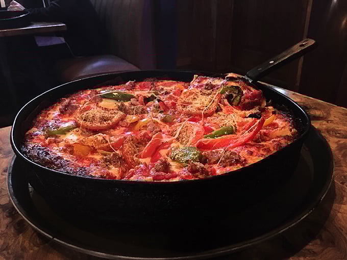 A colorful pan pizza loaded with toppings that somehow maintains structural integrity – engineering and culinary arts in perfect harmony.