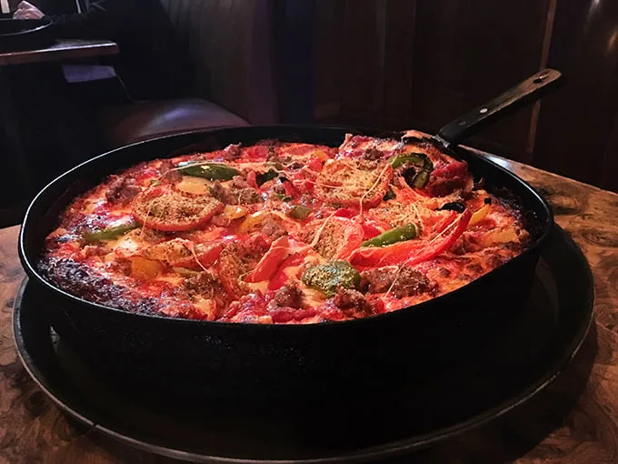 A colorful pan pizza loaded with toppings that somehow maintains structural integrity – engineering and culinary arts in perfect harmony.