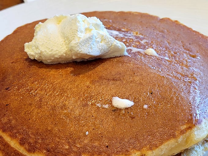 Pancakes arrive looking like they posed for their own magazine cover shoot before hitting your table.