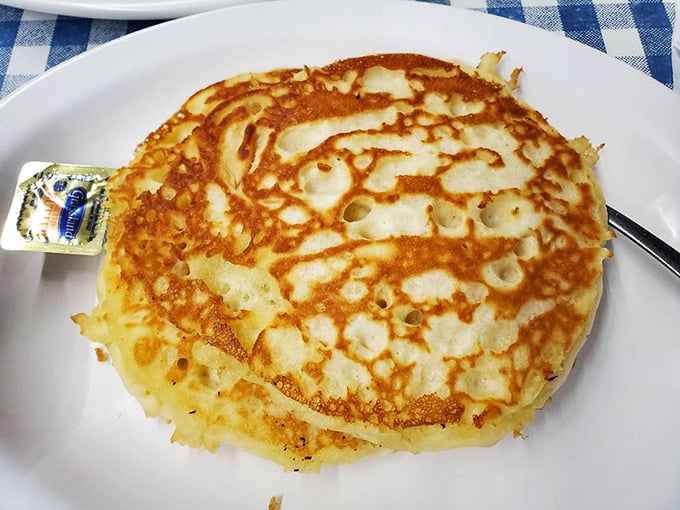 This pancake isn't just golden brown – it's the kind of perfect disc that makes you wonder if they hired a pancake artist.