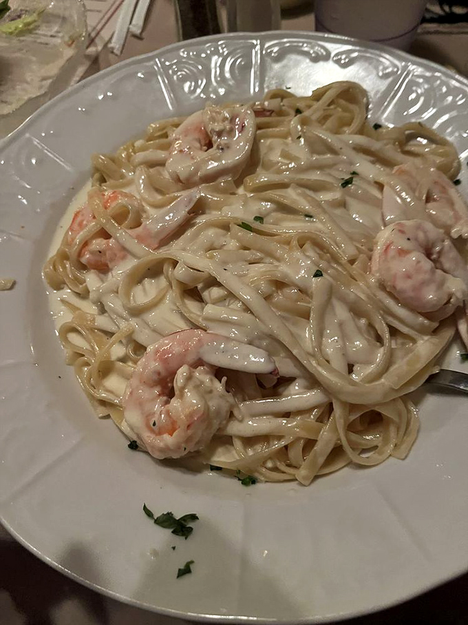 Linguine with shrimp in a sauce so silky it could moonlight as a luxury bedsheet – simple perfection that Italian grandmothers would approve.