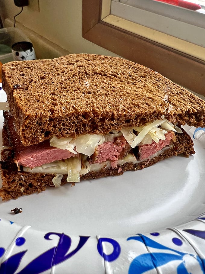 This Reuben isn't just a sandwich, it's architecture – layers of house-smoked pastrami, tangy sauerkraut, and melty cheese creating the Taj Mahal of lunch options.