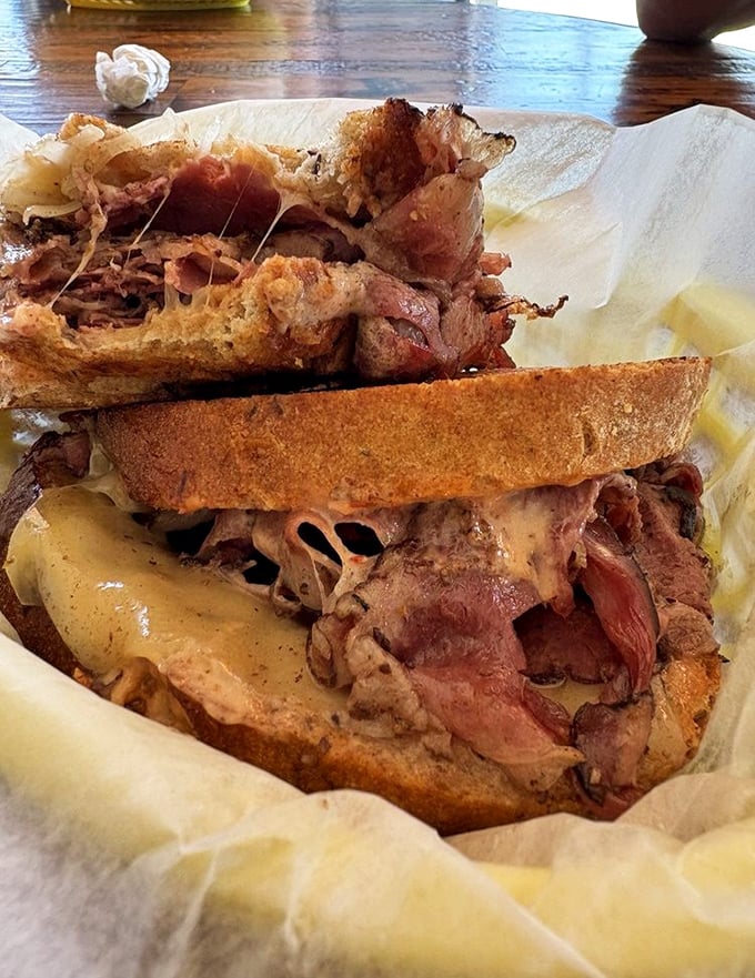 Not just a sandwich, but a meat monument—pastrami piled so high you'll need to unhinge your jaw like a python eyeing a particularly ambitious meal.