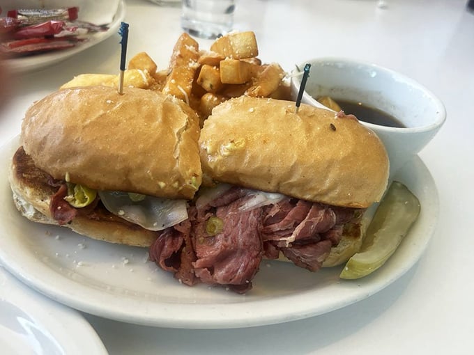 This pastrami sandwich isn't messing around—it's a skyscraper of meat and bread that requires both hands and a strategy.