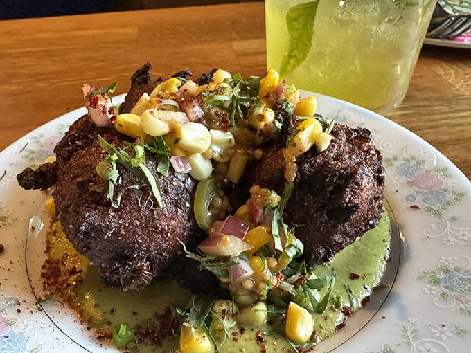 These fritters don't just sit on the plate—they command attention with their perfect crust and vibrant corn salsa topping.