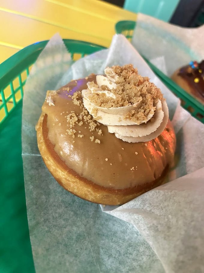 This isn't just a peanut butter donut—it's childhood nostalgia with a grown-up twist, topped with what appears to be cookie crumbles and caramel.