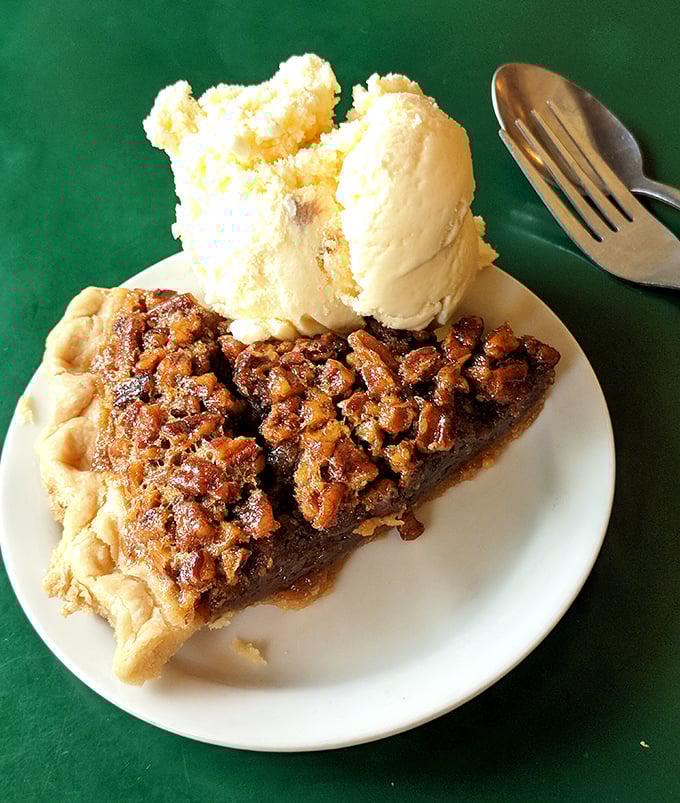 This pecan pie isn't just dessert, it's architecture—a perfect foundation of flaky crust supporting a caramel-sweet filling crowned with crunchy nuts.