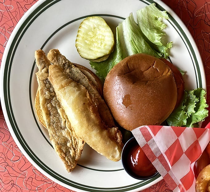 Lake Erie perch gets the royal treatment in this golden-fried sandwich, served with a pickle spear standing guard like a tasty sentinel.