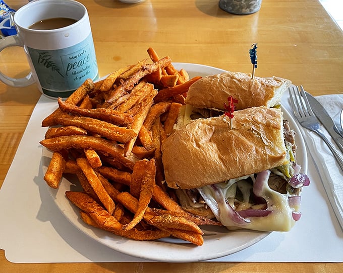 A proper sandwich demands respect, and this Philly cheesesteak with sweet potato fries commands attention like Meryl Streep in any movie ever.