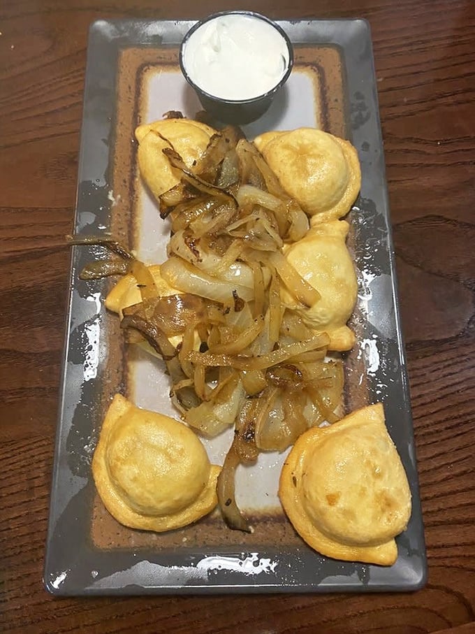 Pierogies lounging in caramelized onions like they're at a day spa. These little dough pockets are Pennsylvania's answer to Italy's ravioli—and they're winning the debate.