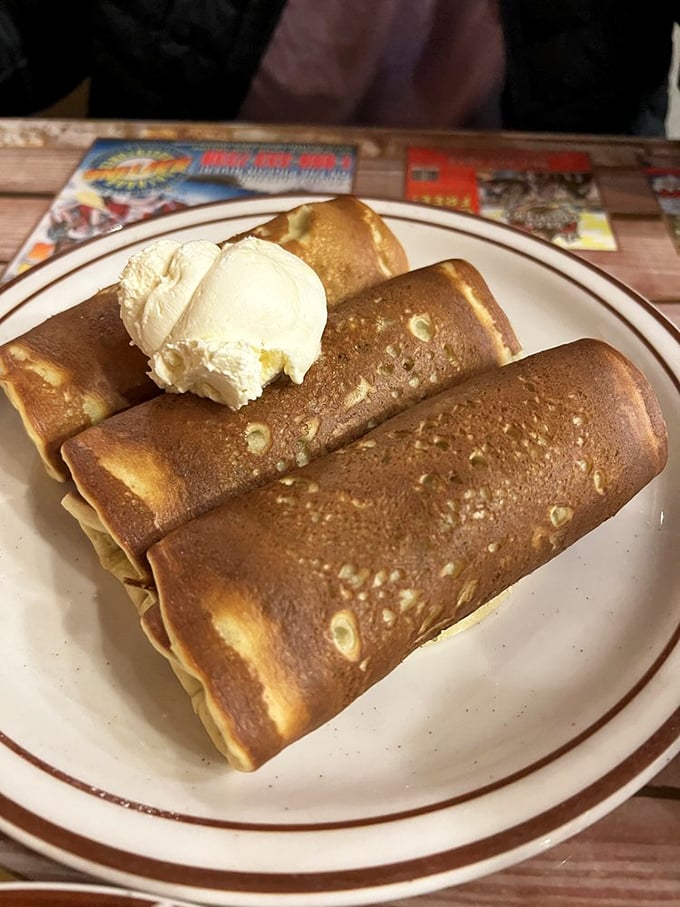 These aren't your average pigs in blankets—they're breakfast royalty wrapped in golden pancake robes with a dollop of butter crown.