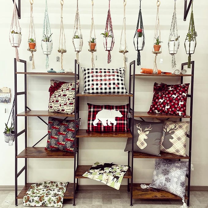 Plant parenthood meets textile artistry in this display where macramé hangers and buffalo plaid pillows create the perfect rustic-modern marriage.
