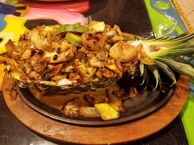 Sizzling fajitas served in a hollowed pineapple – proof that presentation and flavor can have a beautiful vacation together.
