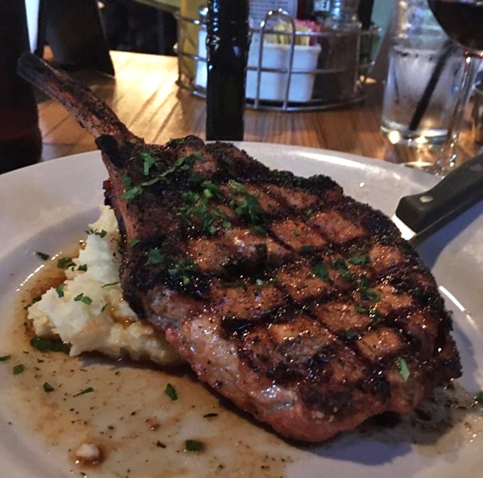 The pork chop that launched a thousand return visits. Perfectly seared with grill marks that deserve their own Instagram account, resting on cloud-like mashed potatoes.