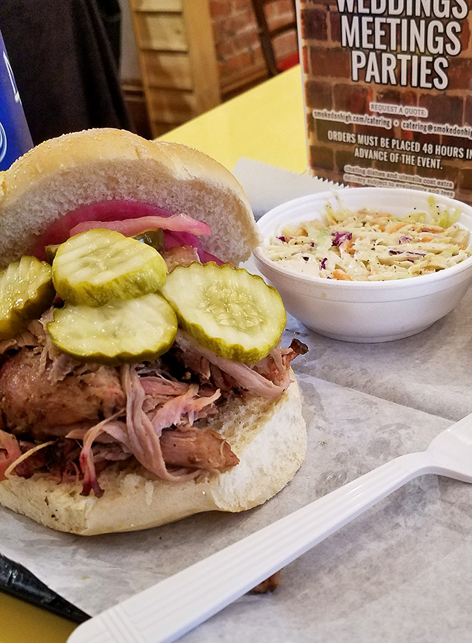 This pulled pork sandwich with pickles and slaw isn't just lunch—it's what happiness would look like if it took physical form.
