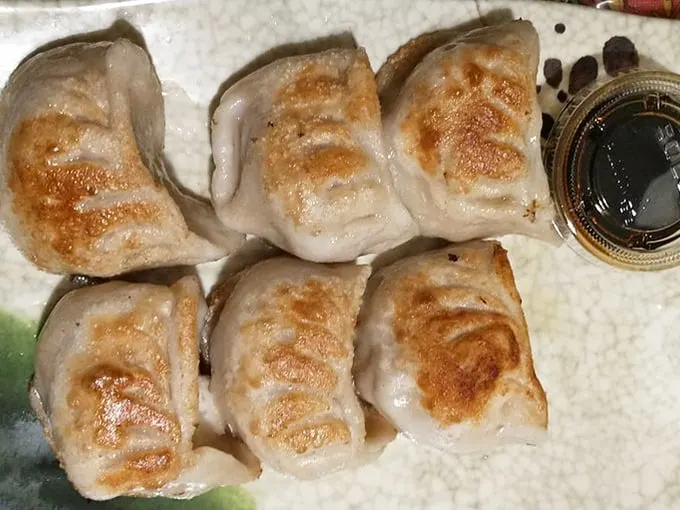 Pot stickers with that perfect sear—crispy bottoms, tender tops. Like the mullet haircut of dumplings, but infinitely more appealing.