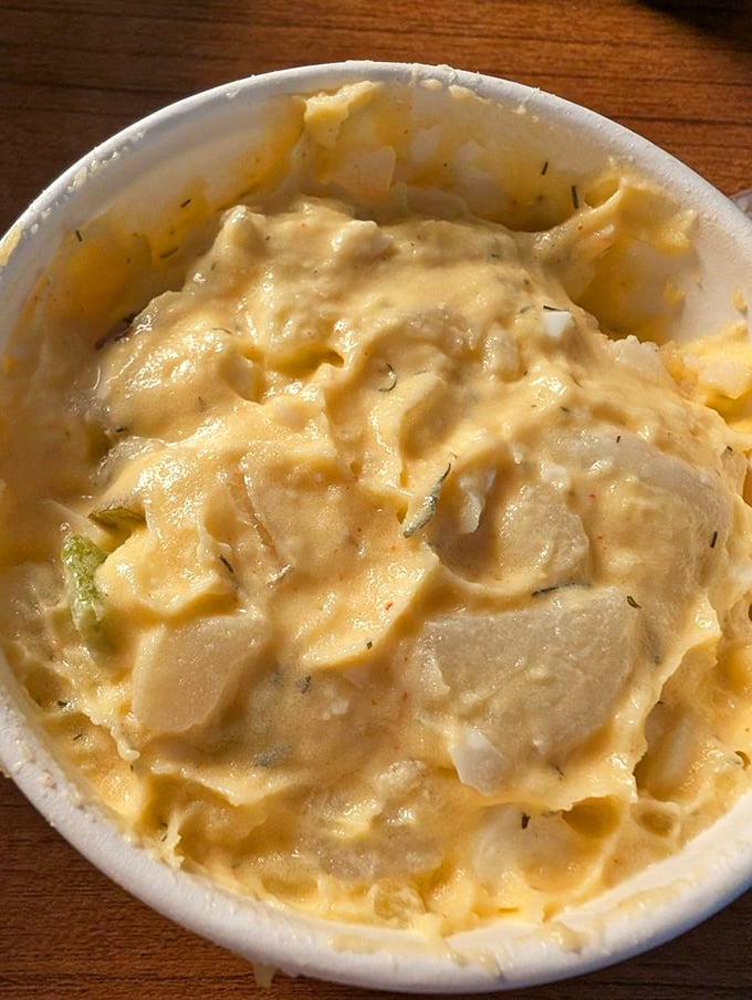 This isn't just potato salad; it's a creamy, mustard-kissed side that refuses to be overshadowed by its meaty companions.
