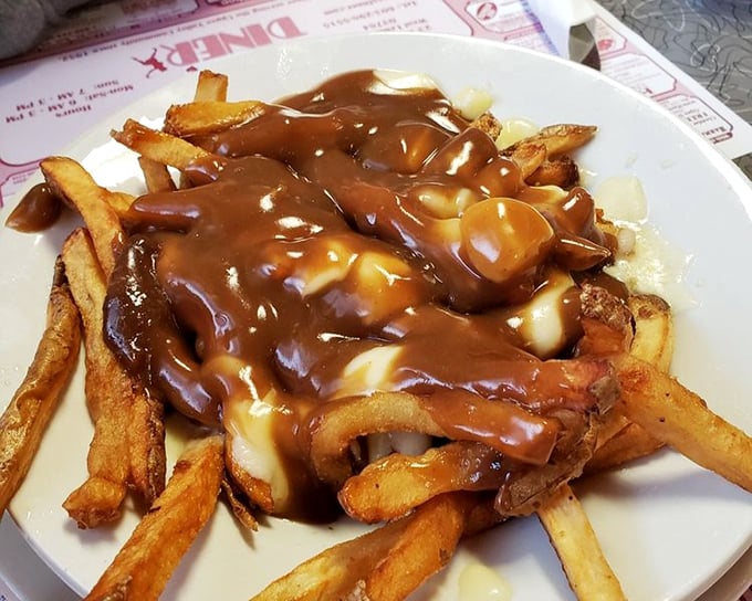 Poutine that doesn't need a passport—golden fries swimming in gravy and cheese curds that would make a Canadian shed a patriotic tear.