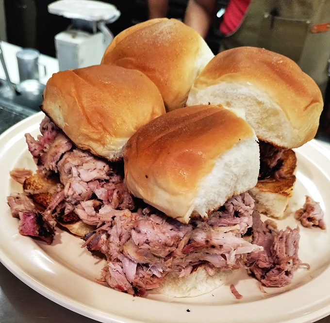 Pulled pork sliders that redefine sandwich architecture – tender meat piled impossibly high between pillowy buns. Napkins required, not optional.