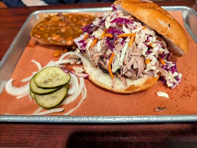 This pulled pork sandwich with vibrant slaw and pickles isn't just lunch—it's a commitment to excellence that rewards your taste buds handsomely.