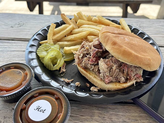 The pulled pork sandwich – where tender, smoky meat meets toasted bun in a relationship more perfect than any Hollywood romance.