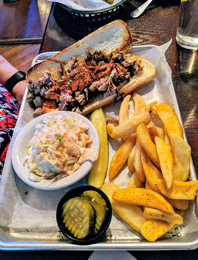 The pulled pork sandwich—where smoke-kissed meat meets pillowy bun in a relationship so perfect it should have its own reality show.