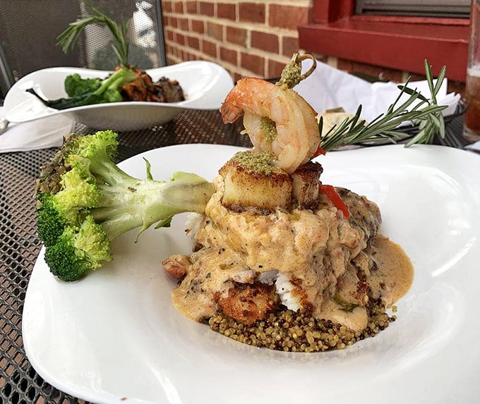 Architectural food at its finest—a tower of flavor where seafood and quinoa collaborate like old friends at a delicious reunion.