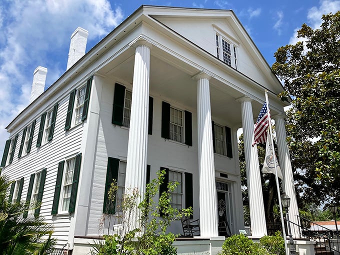 The Raney House stands as a pristine example of antebellum architecture, its stately columns practically demanding you sip a mint julep on the porch.