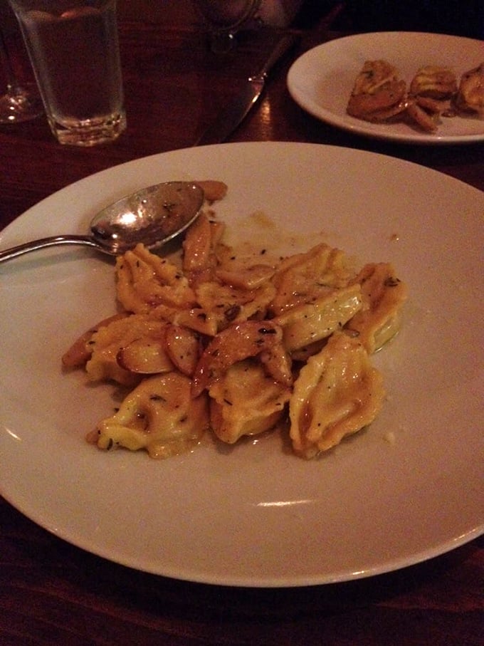 These ravioli aren't just filled, they're fulfilled. Bathed in a buttery sauce that glistens under the restaurant's warm lighting like liquid gold.