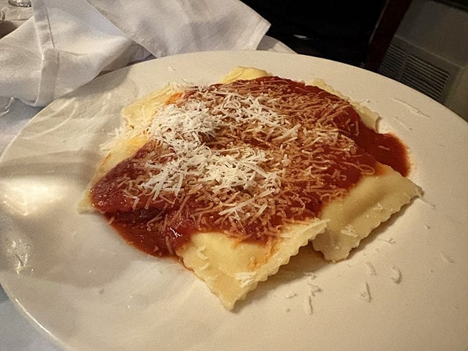 These ravioli aren't just pasta pockets—they're little envelopes of joy, delivering their cheese-filled message with each bite under a blanket of rich sauce.