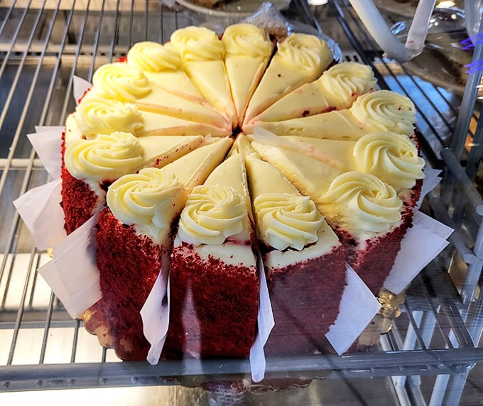 Red velvet cake sliced with mathematical precision—each piece promising the perfect frosting-to-cake ratio that dessert engineers dream about.