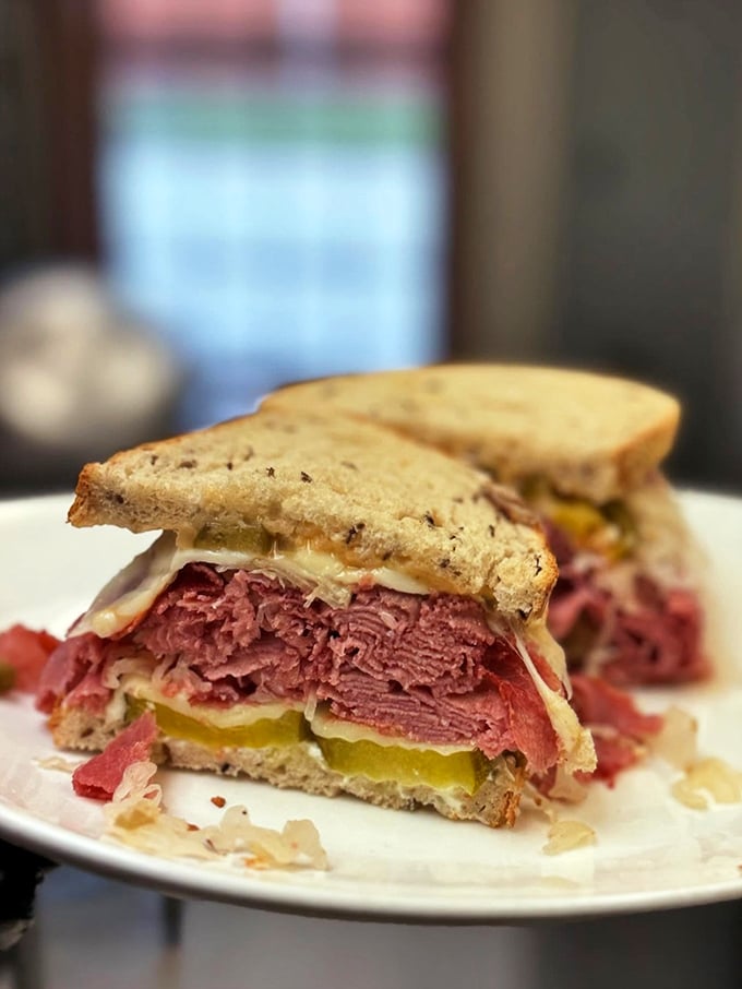 The legendary Reuben in all its glory—a monument to the perfect marriage of corned beef, sauerkraut, and Swiss that would make even New York delis envious.