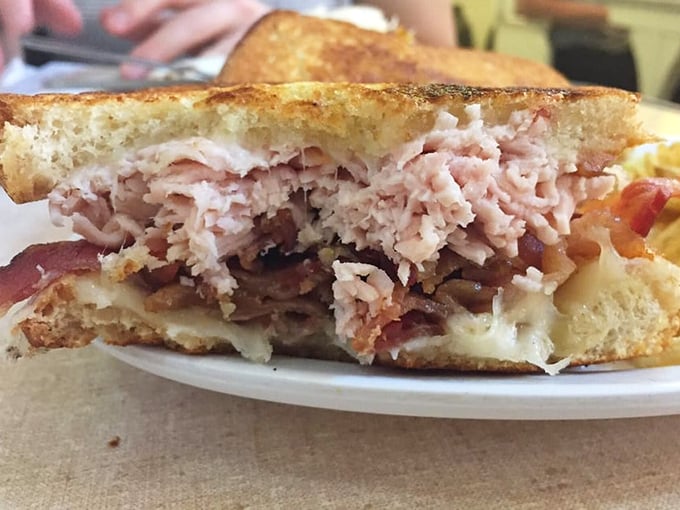 Cross-section evidence of sandwich perfection—where turkey, bacon, and melted cheese create a triumvirate of flavor that should be studied in culinary schools.
