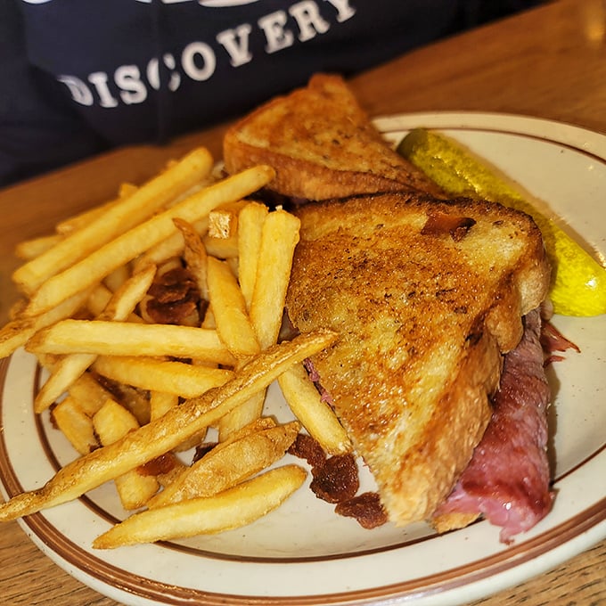 The Reuben sandwich – where toasted bread, melted cheese, and thinly sliced meat perform a perfect three-part harmony. Those fries aren't just a side, they're co-stars.