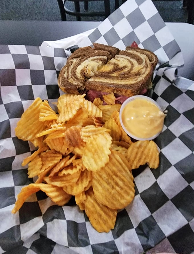 The marbled rye swirl on this Reuben is hypnotic, the chips perfectly ridged. This sandwich isn't just lunch—it's an afternoon delight.