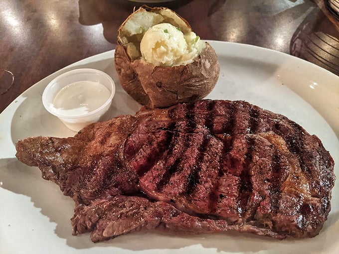 A steak with grill marks so perfect they could be framed in a museum. The potato's just showing off with that butter pool.