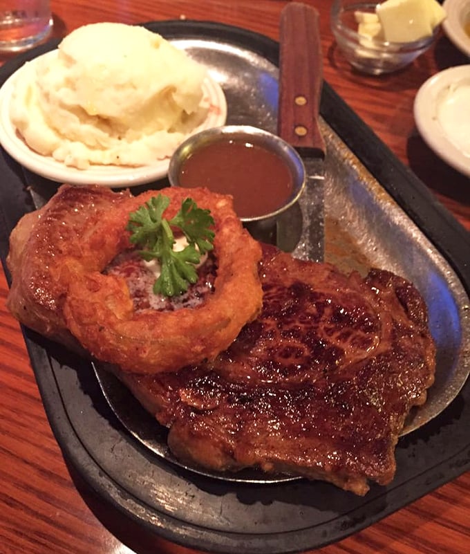 A steak seared to perfection, mashed potatoes with a gravy lake in the middle—this plate understands the meaning of "comfort food."