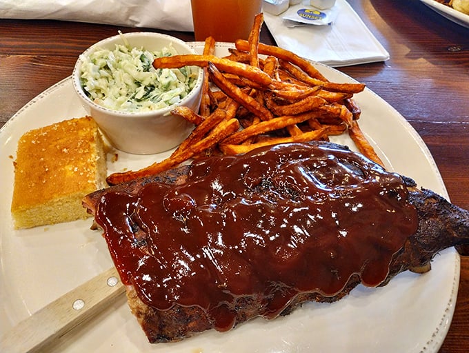These ribs aren't falling off the bone—they're voluntarily surrendering after being lovingly bathed in sauce that should be bottled and sold as cologne.