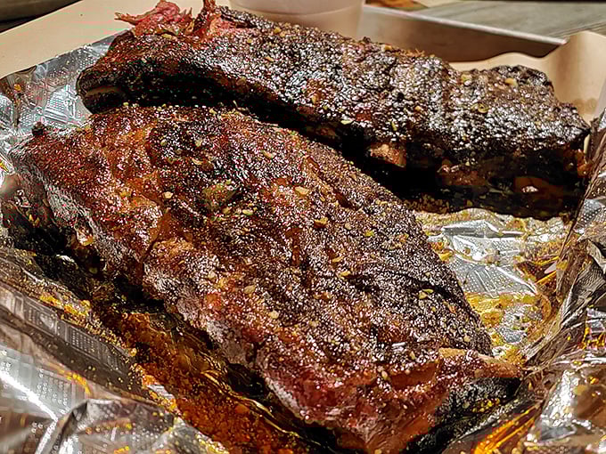 These ribs wear their bark like a badge of honor—the telltale smoke ring revealing hours of patient craftsmanship and flavor-building.