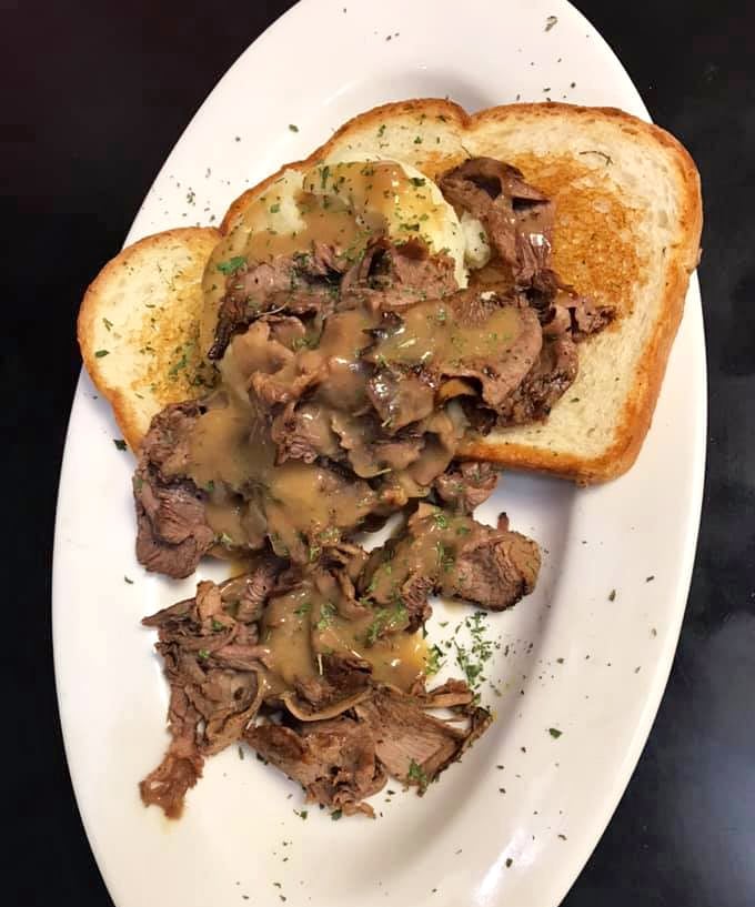 Open-faced roast beef with gravy—comfort food that whispers, "Don't worry about that afternoon meeting; focus on this moment of meaty bliss."