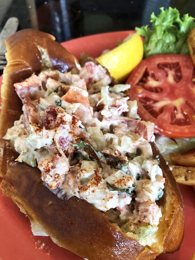 That lobster roll is piled so high with sweet meat, it's practically defying the laws of sandwich physics.