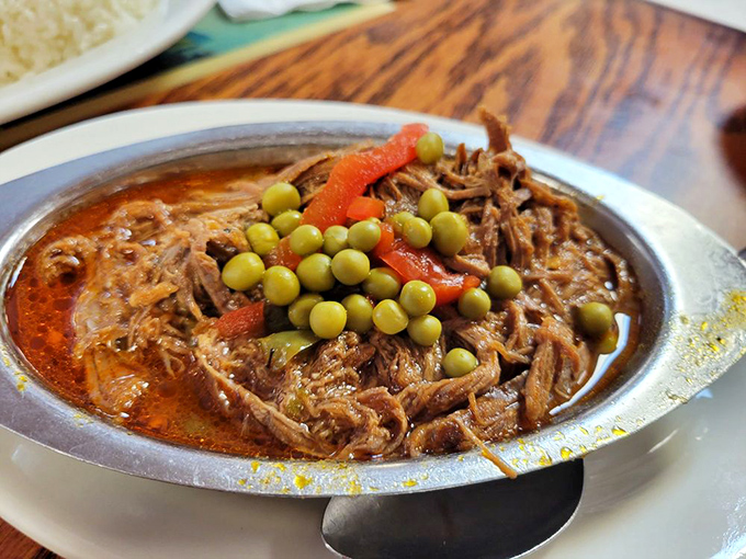 Ropa Vieja—"old clothes" that taste like new revelations. Shredded beef swimming in tomato sauce with green peas standing sentry.