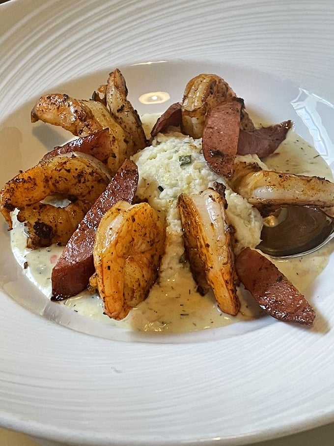 Shrimp and grits elevated to art form—plump shrimp surrounding creamy grits with andouille sausage creating a flavor symphony that would make New Orleans jealous.